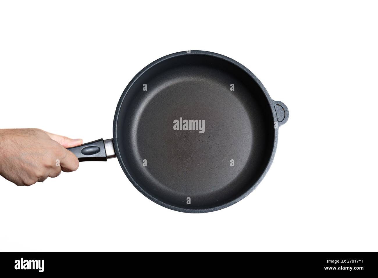 Used and lightly scratched non stick pan held by Caucasian male hand ...