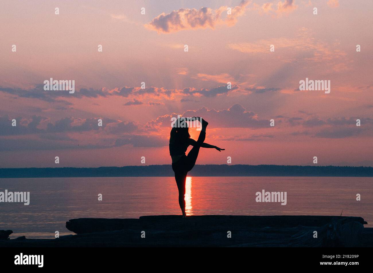 Silhouette person performing yoga sunset hi-res stock photography and ...