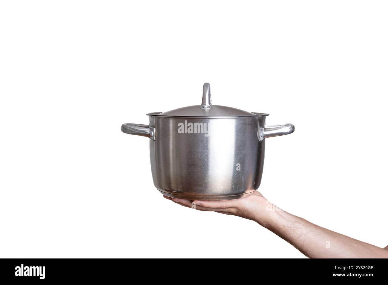 Stainless steel stock cooking pot with lid. Held by hand by Caucasian ...