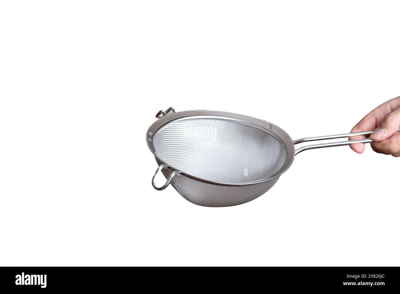 Stainless steel sieve. Held by hand by Caucasian male hand. Close up ...