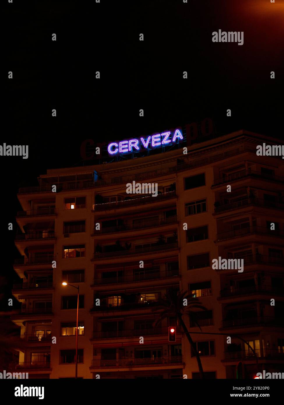 Neon sign reading 'CERVEZA' atop an urban building at night Stock Photo ...