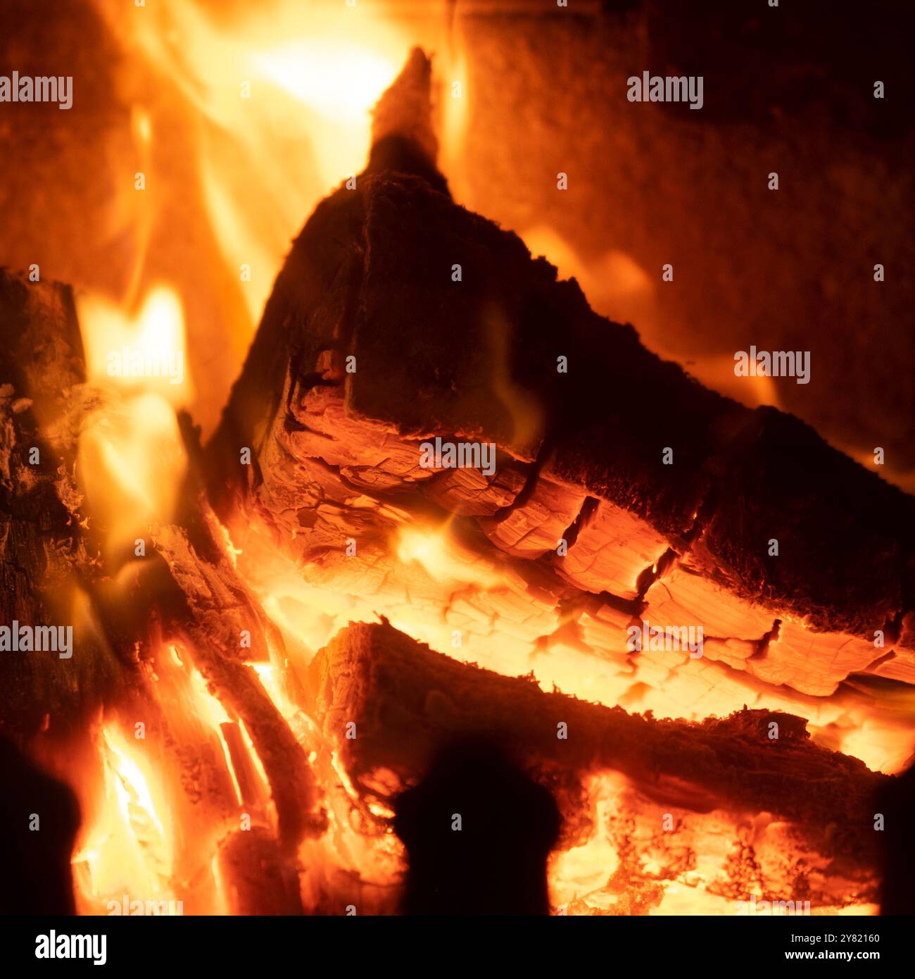 Log fire logs burning glowing in an Villager wood stove in a room house ...