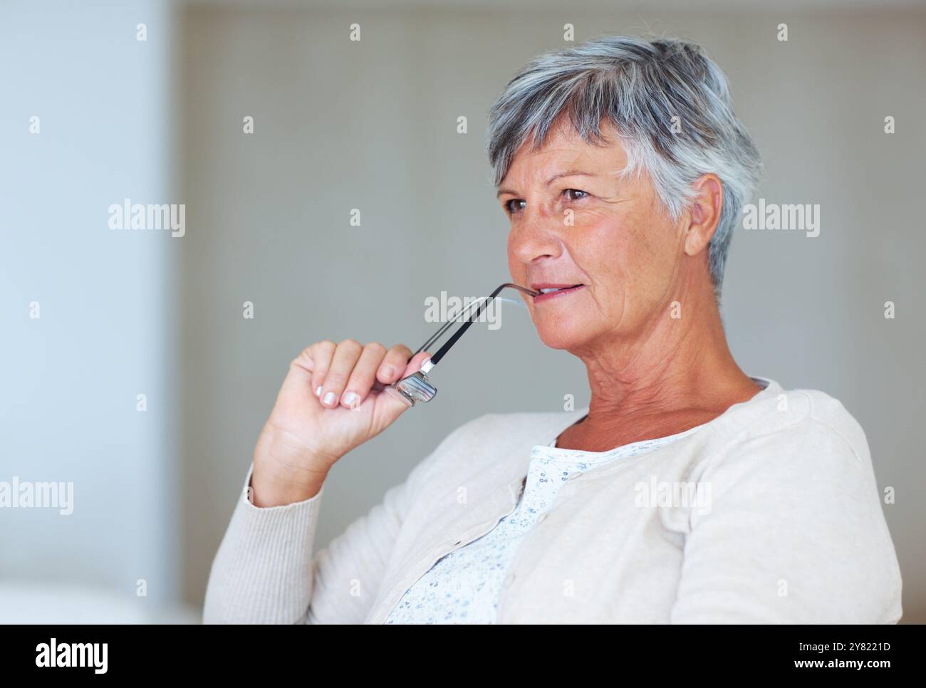 Senior woman, thinking and glasses in home, morning reflection and remember memory in lounge ...