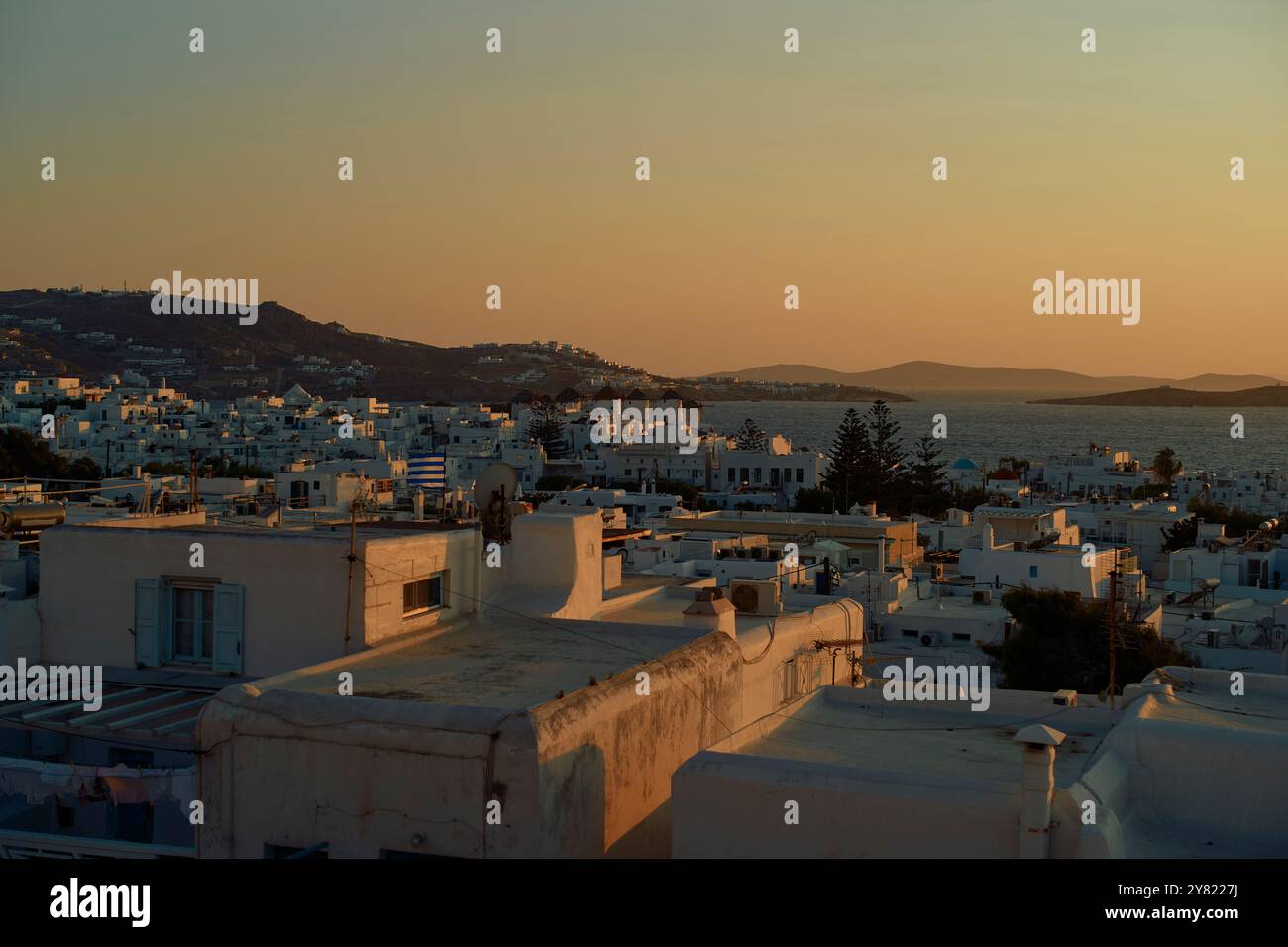 Sunset view over a picturesque coastal town with white buildings and ...