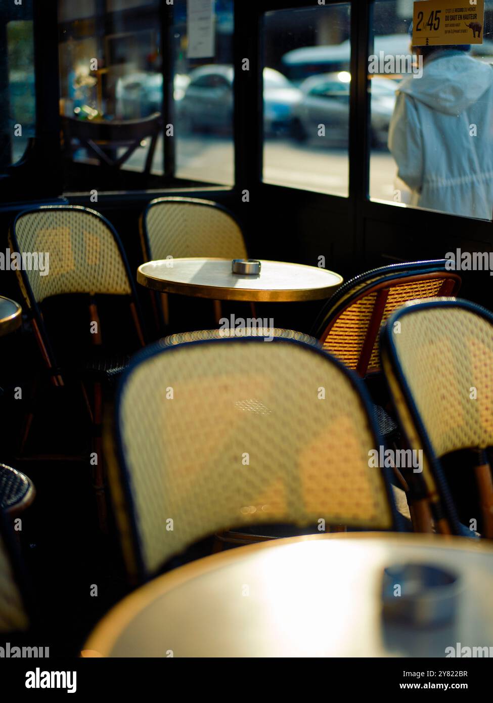 Sunlight filters through a window illuminating an empty cafe interior ...
