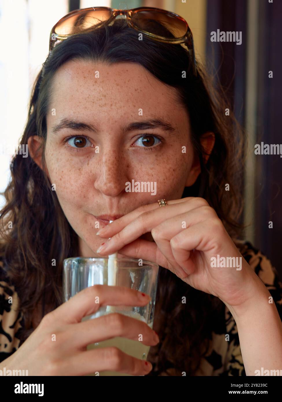Woman sipping through straw hi-res stock photography and images - Alamy