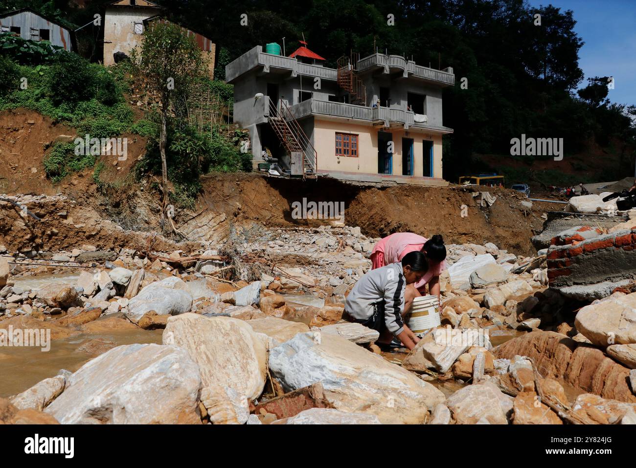 On October 1,2024, in Kavre, Nepal. Women wash their dishes near the ...