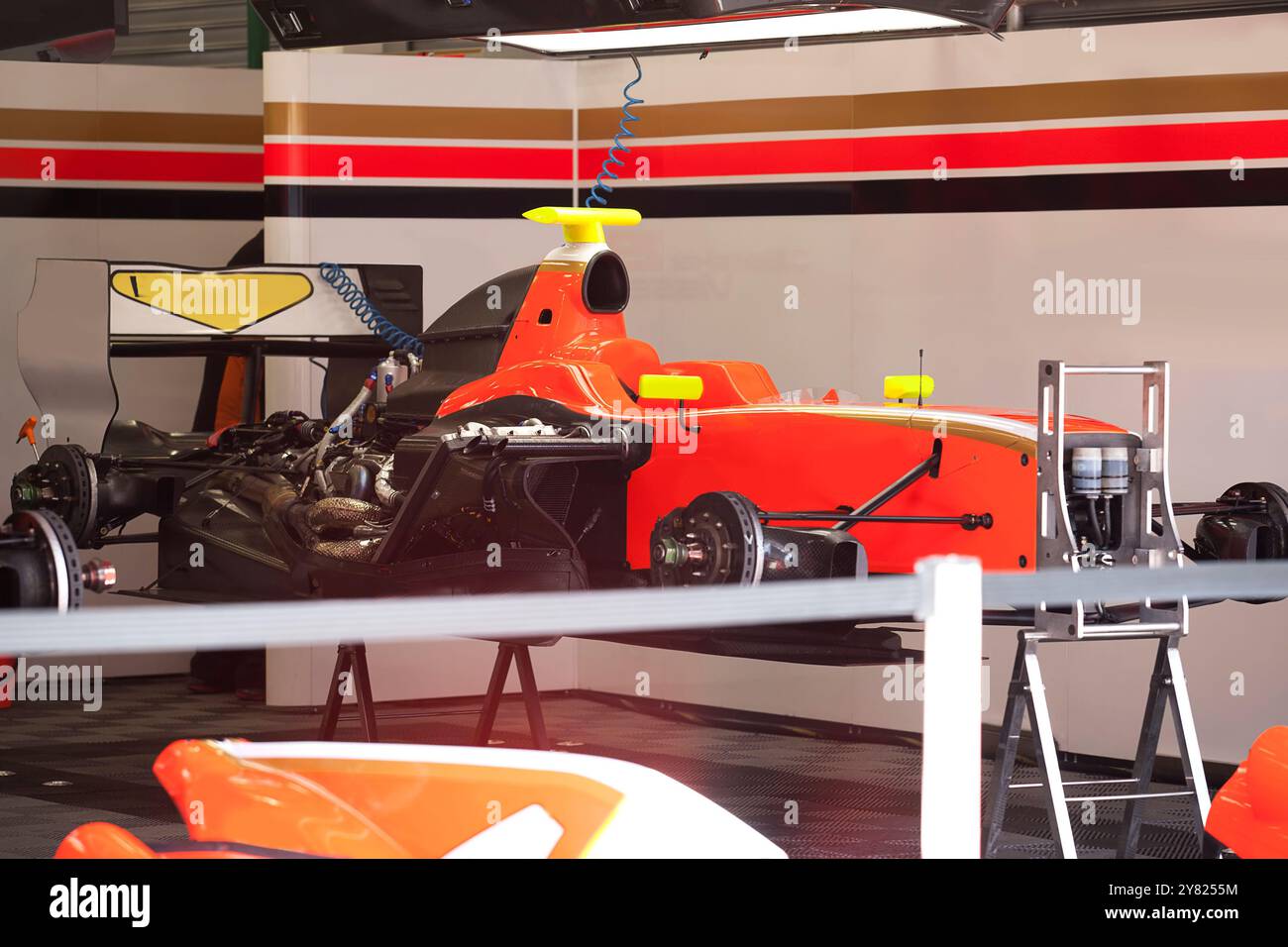 Racing car Formula 1 is being serviced in the garage Stock Photo - Alamy
