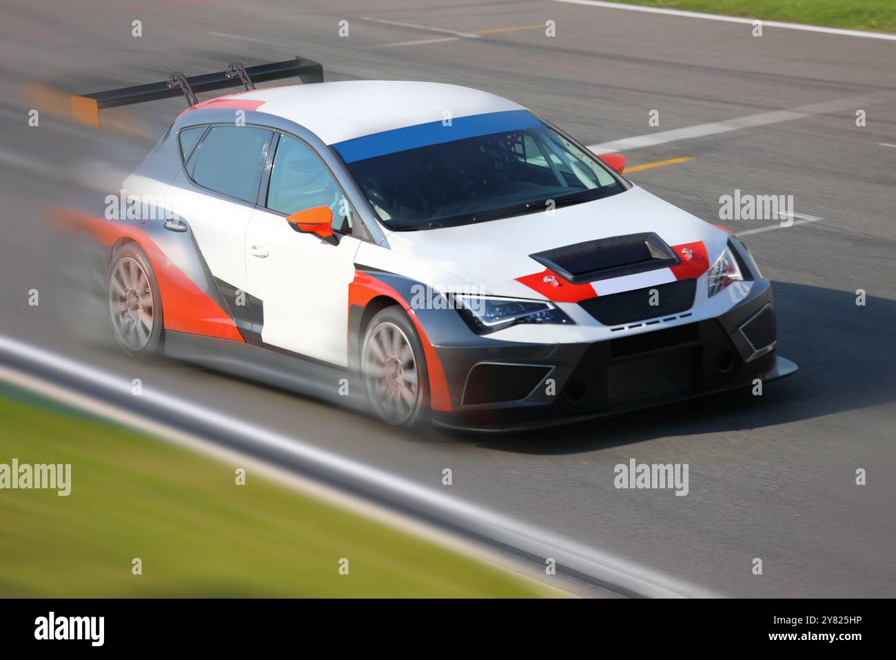 Race car racing at high speed on speed track Stock Photo - Alamy
