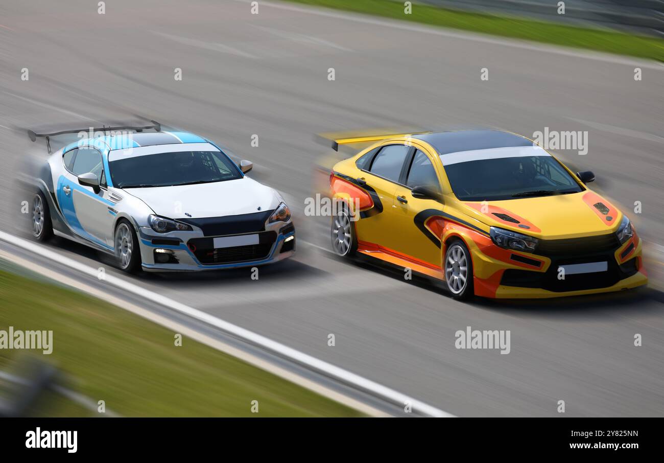Two race cars racing at high speed on speed track with motion blur at ...