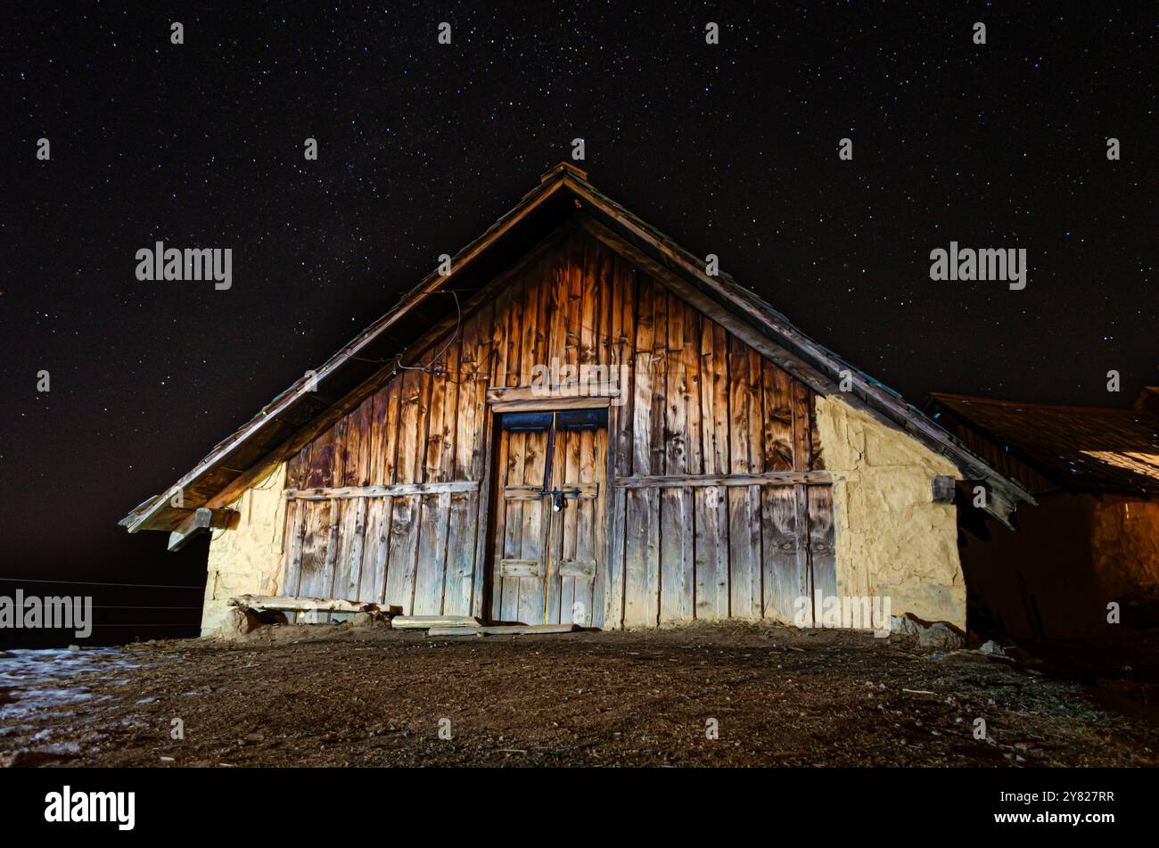 A house in rural landscape at night with starlit sky, Himachal Pradesh ...