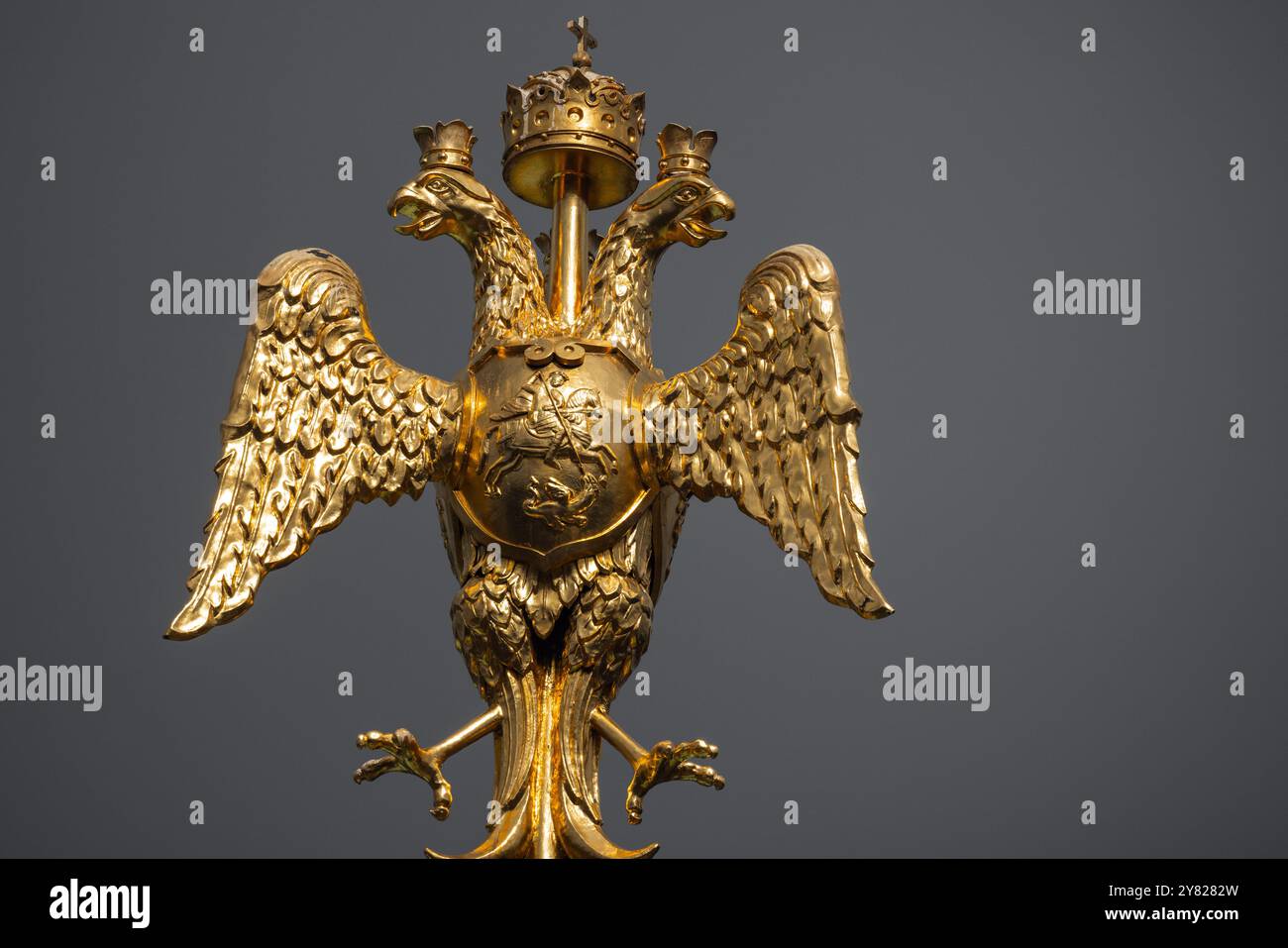 Two-headed eagle, Russian coat of arms is on dark gray sky background. Symbol of imperial Russia ...