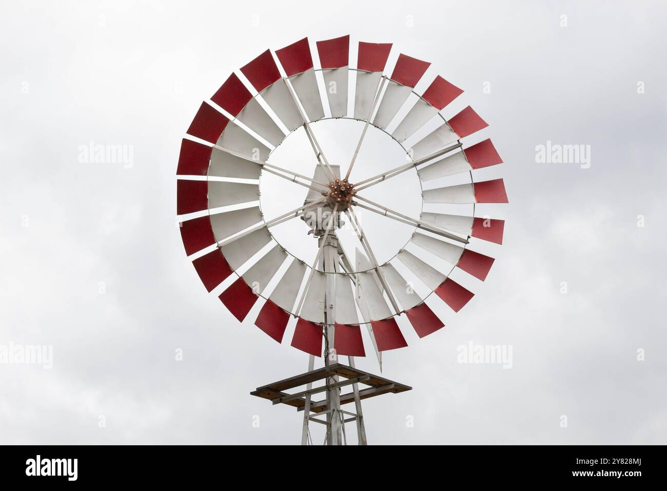 White and red windmill with grey sky at background Stock Photo - Alamy