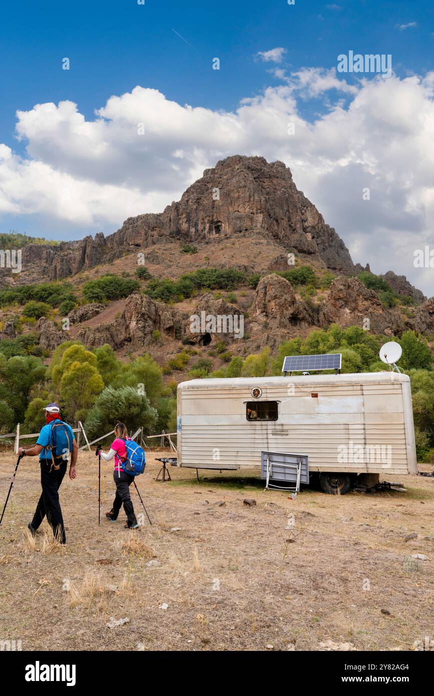 Camper trailer with solar panel and satellite dish in nature. Trekkers ...