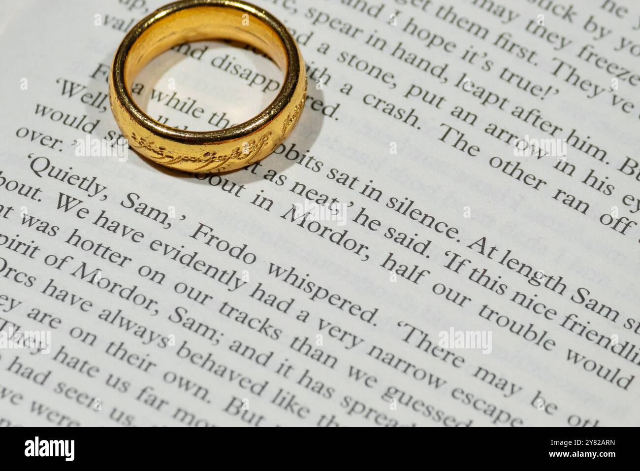 Close up to The ring of power of sauron over a Lord of the rings text ...