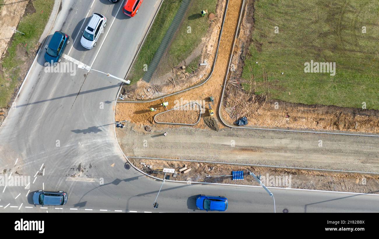 Aerial view of a sidewalk under construction with workers and equipment ...
