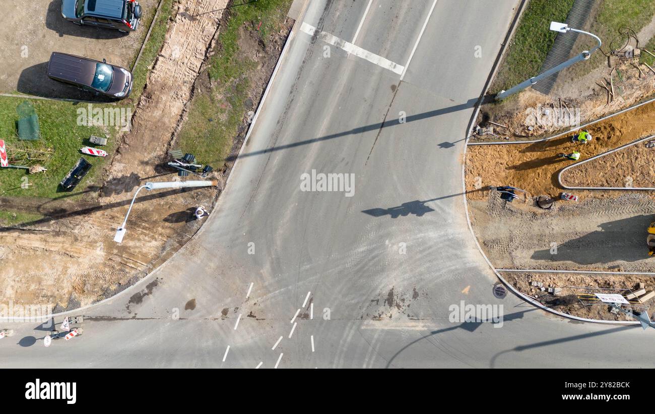 Aerial view of a sidewalk under construction with workers and equipment ...