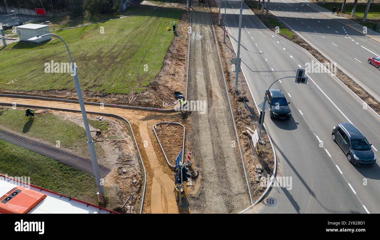 Aerial view of a sidewalk under construction with workers and equipment ...
