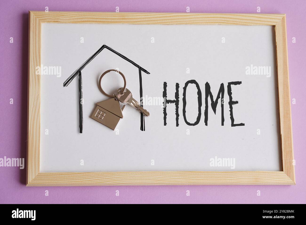 HOME. word written next to the key of a house Stock Photo - Alamy
