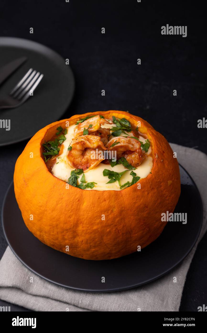 Whole baked pumpkin with tiger prawns, melted cheese and tomatoes ...
