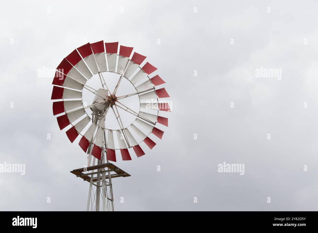 Closeup to a white and red windmill with grey sky at background Stock ...