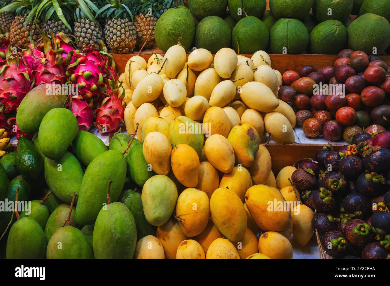 assortment of various tropical fruits on the market in Asia. Exotic ...