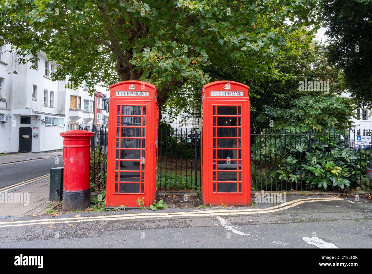 Two Red Telephone Boxes and a Red Postbox Stock Photo - Alamy