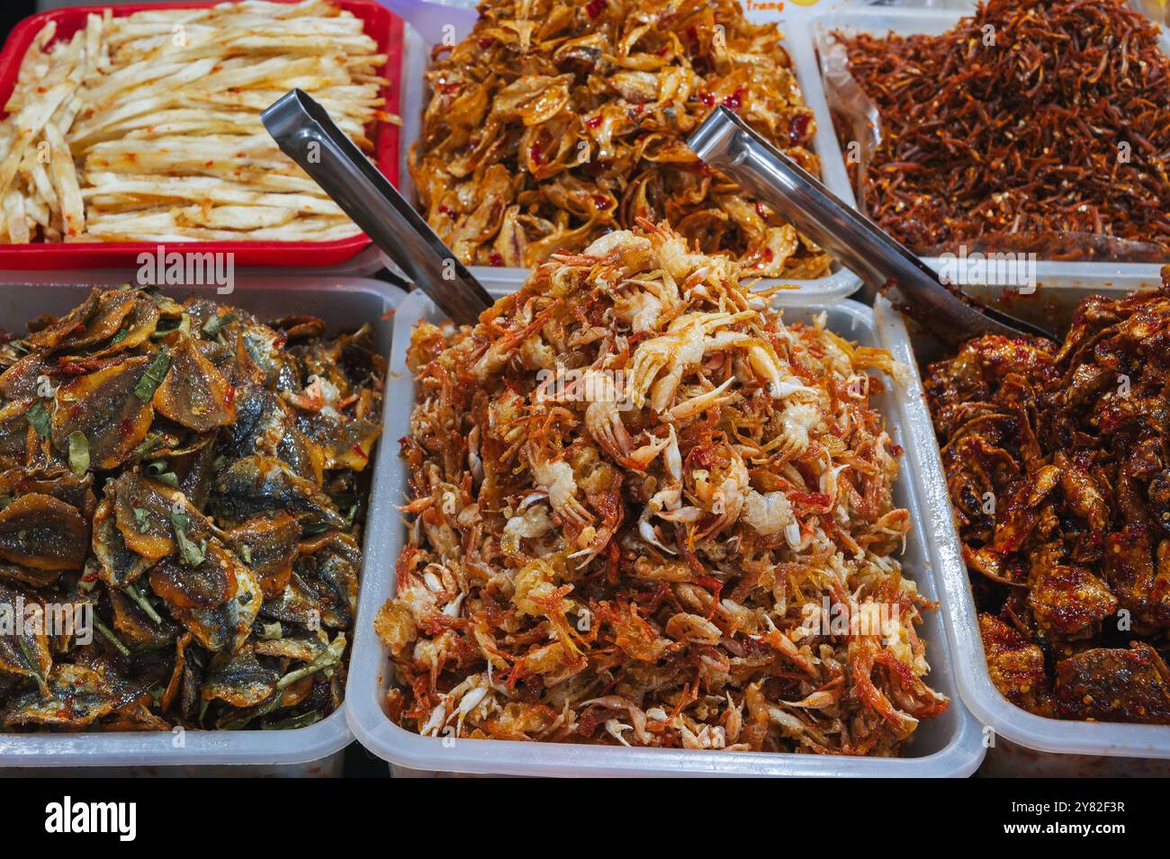 dried fish and canned seafood on the counter at the Asian market in ...
