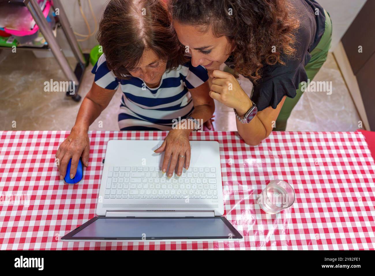 Middle-Aged Daughter Teaching Elderly Mother to Use a Laptop, Bridging ...