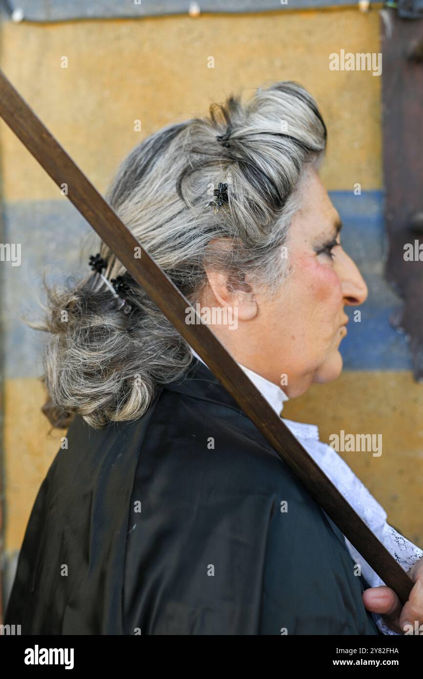 Older person exudes power holding a sword in a historical costume ...