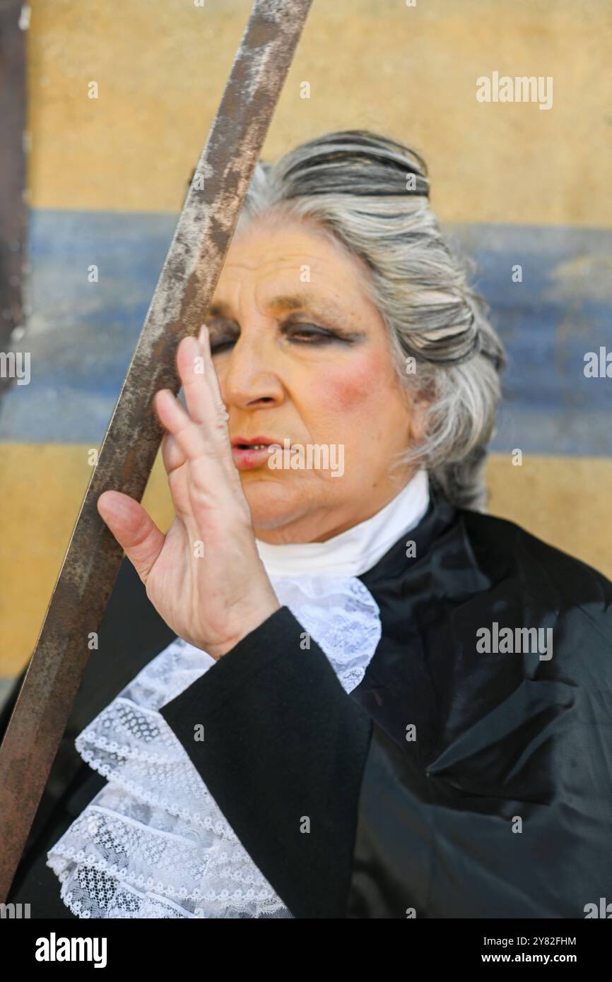 Senior judge woman is stroking a sword with a greedy and sinister ...