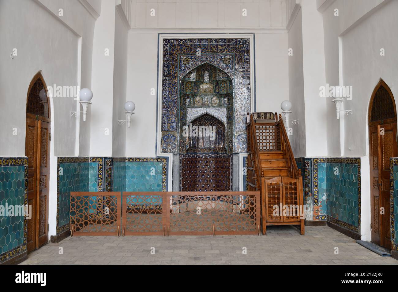 The medieval mihrab decorated with glazed colorful tiles and the modern ...