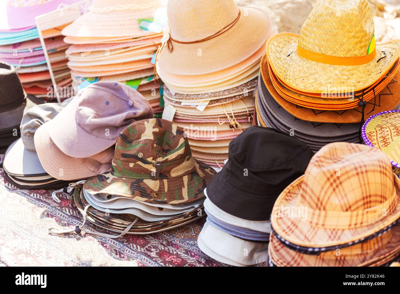 A large collection of hats is neatly stacked on top of each other Stock ...