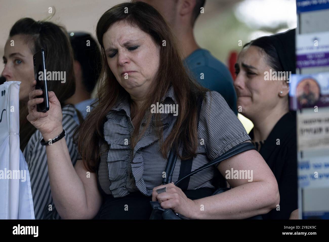 A mourner weeps at the funeral for Israeli Army Capt. Eitan Yitzhak ...