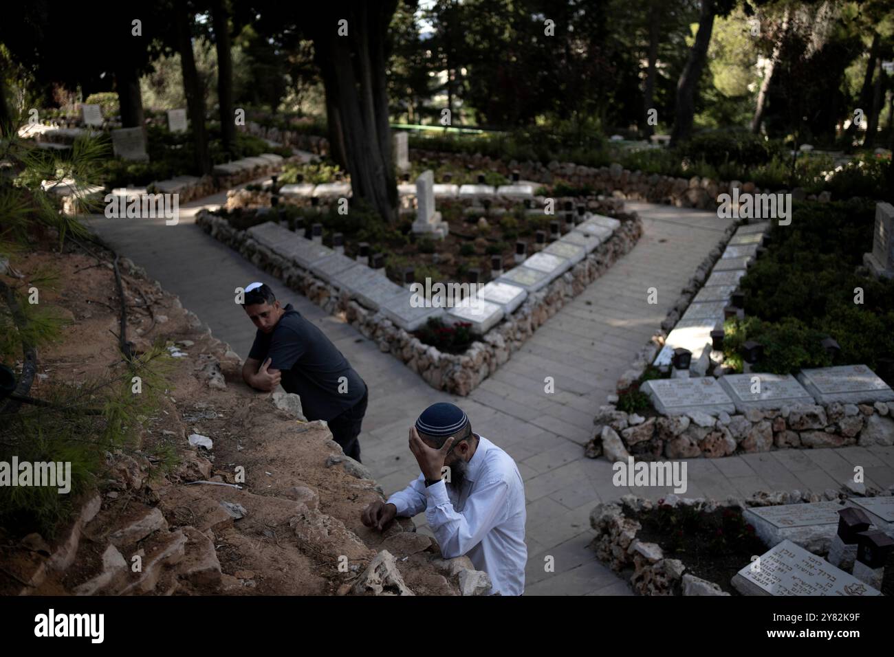 A mourner weeps at the funeral for Israeli Army Capt. Eitan Yitzhak ...