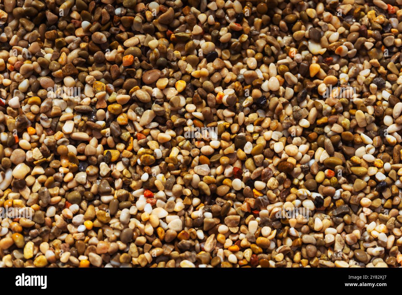 Small pebbles on the beach texture close up Stock Photo - Alamy