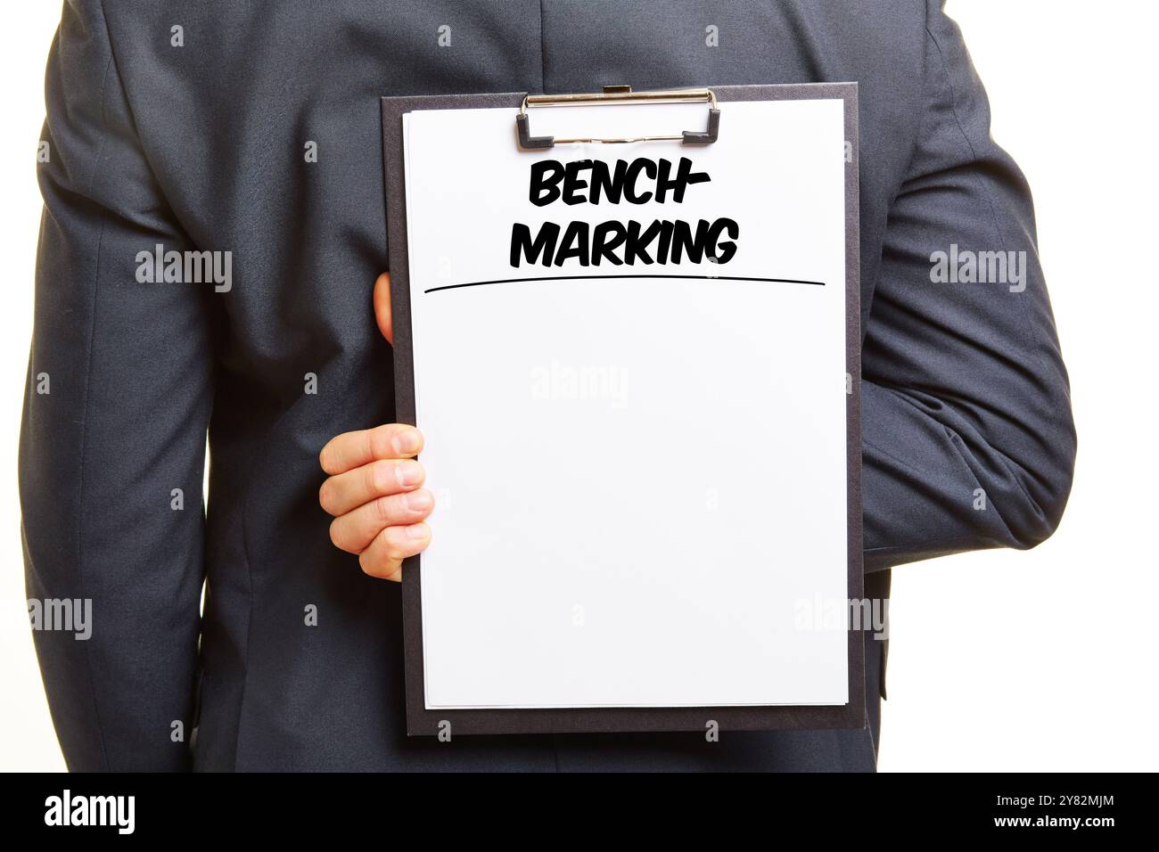 Businessman holding clipboard with text space and heading Benchmarking ...