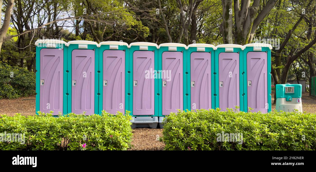 Portable mobile toilets in the park. A line of chemical WC cabins for ...