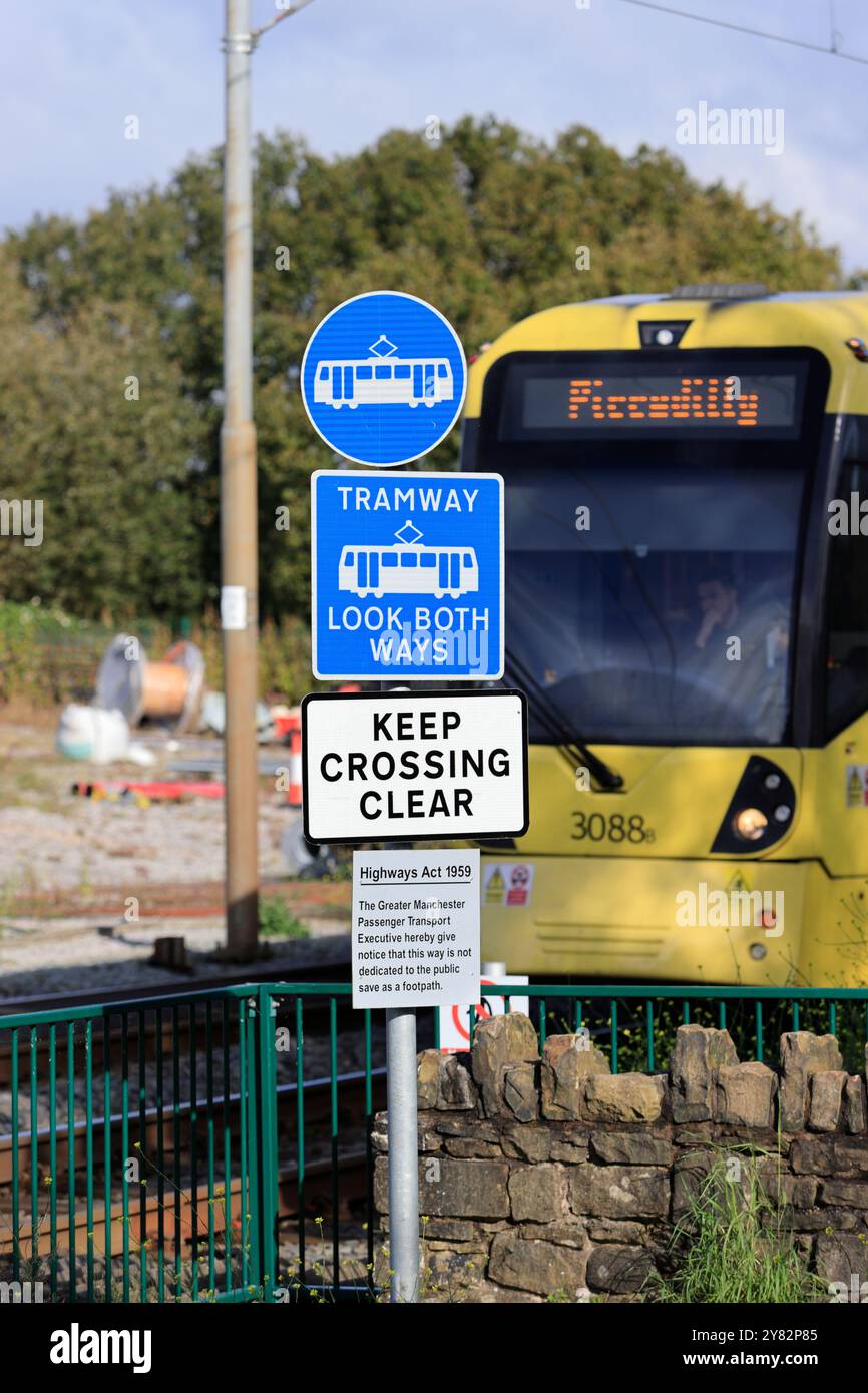Blue and white tram warning signs at tramway with bee network metrolink ...