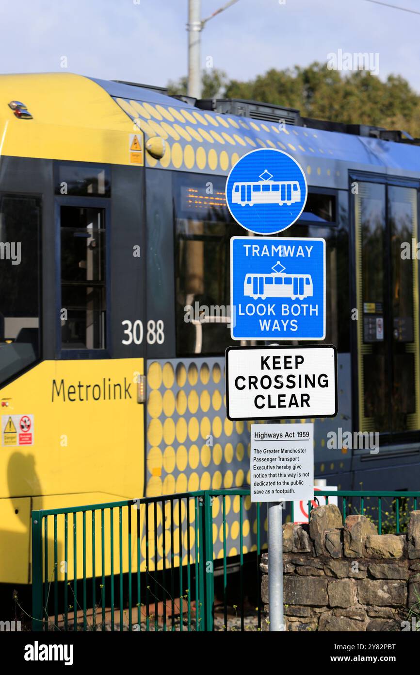 Blue and white tram warning signs at tramway with bee network metrolink ...