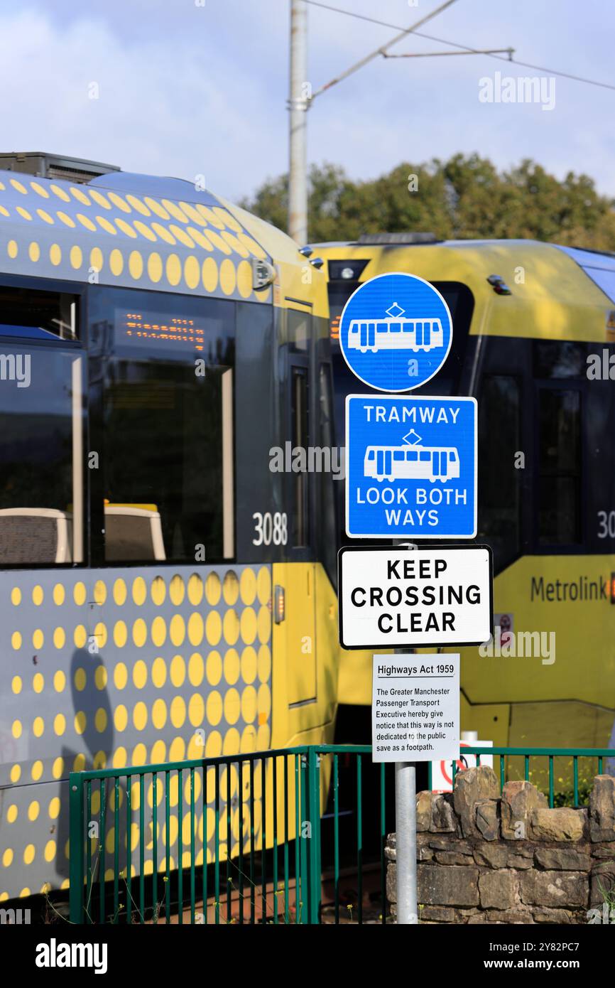 Blue and white tram warning signs at tramway with bee network metrolink ...