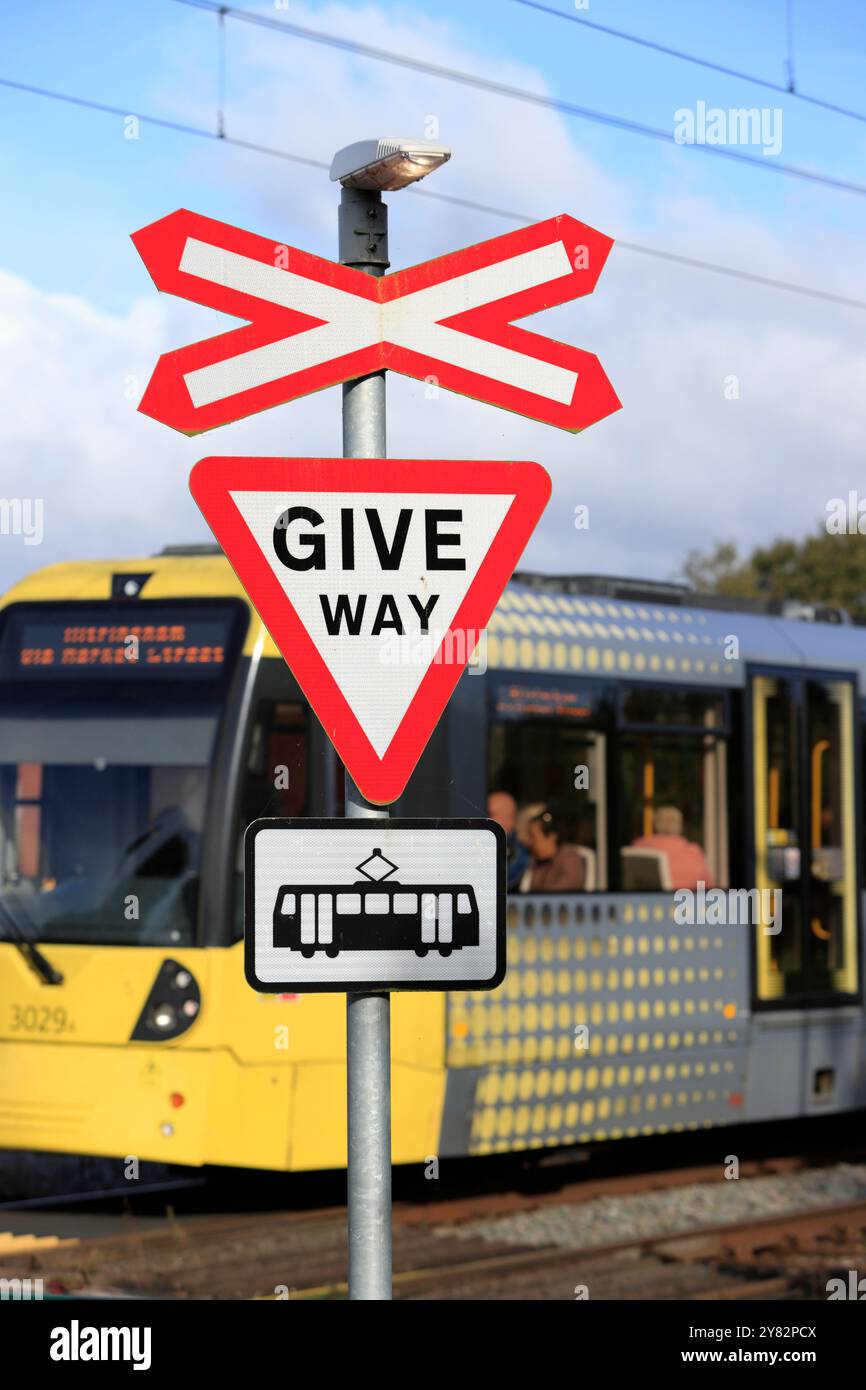 Give way warning sign and black and white tram sign at tram crossing ...