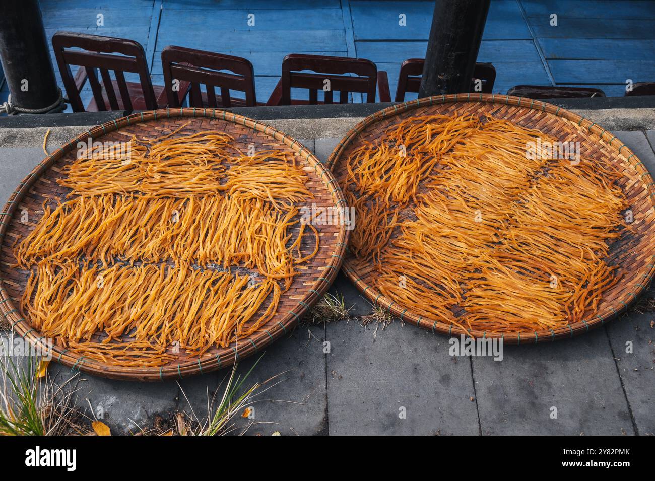 dried fish sticks are dried in the sun at a market in Vietnam in Asia ...