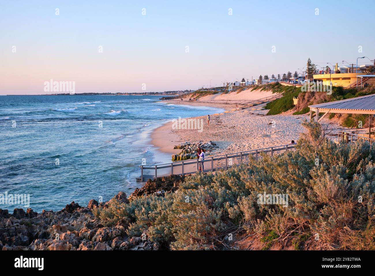 Mettams Pool at sunset with coastal vegetation and limestone rocks in ...