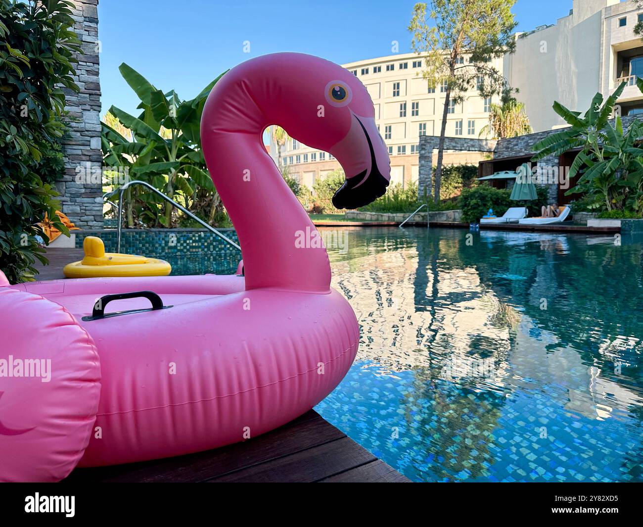 Outdoor swimming pool with clear water and inflatable float in shape of ...