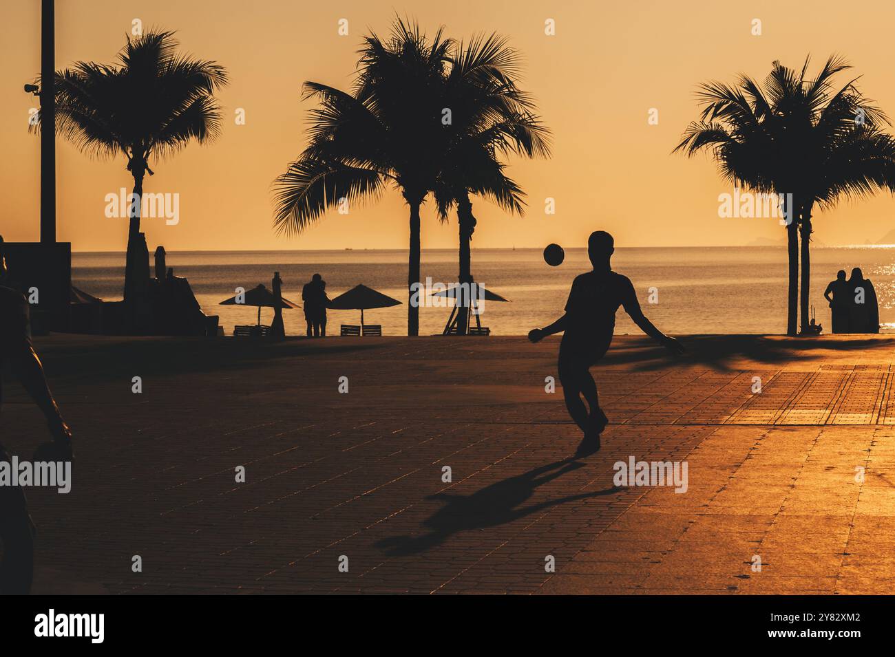 silhouettes of male players playing traditional football sepak takraw ...