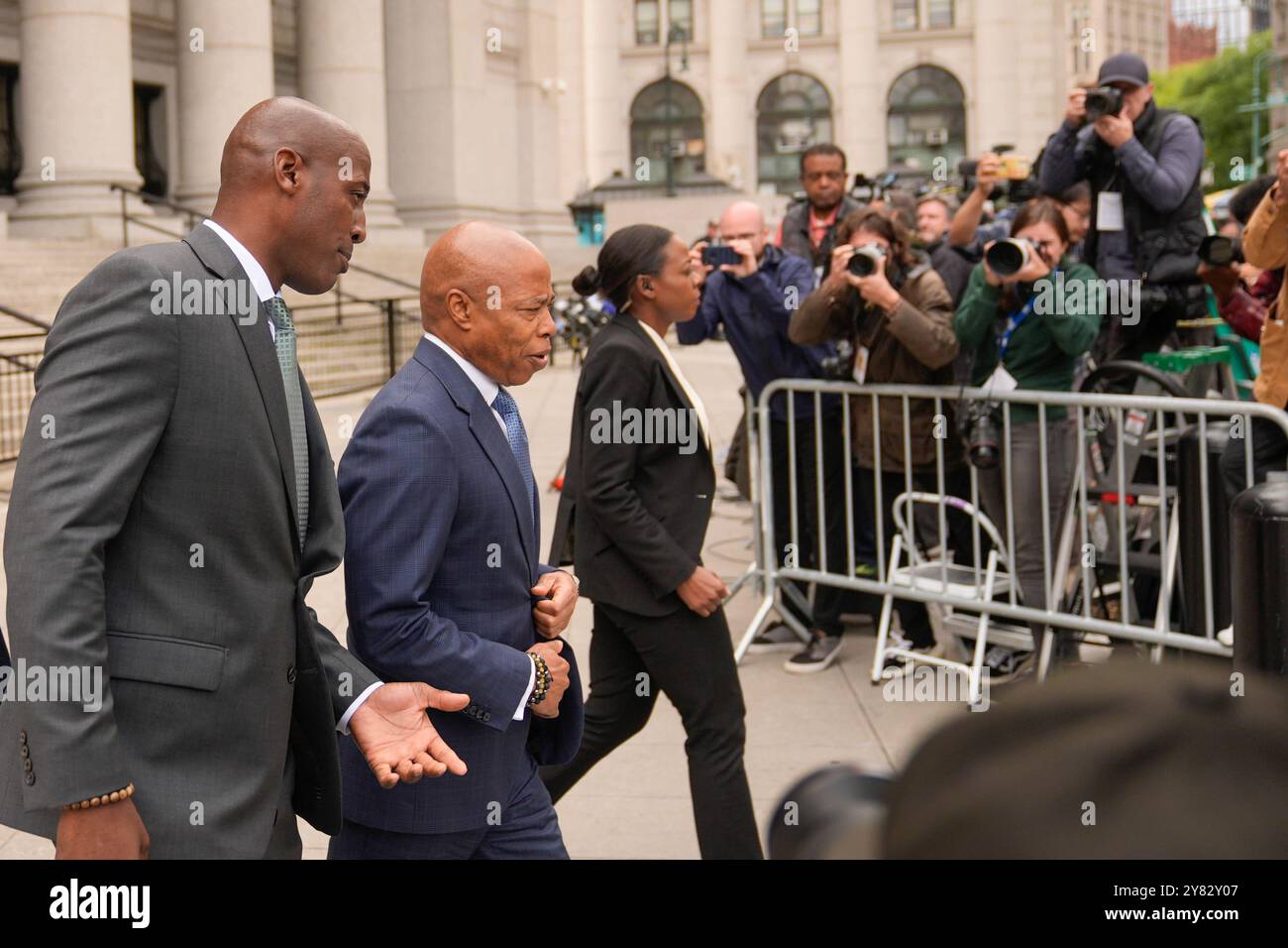 New York City Mayor Eric Adams, second from left, leaves the courthouse ...