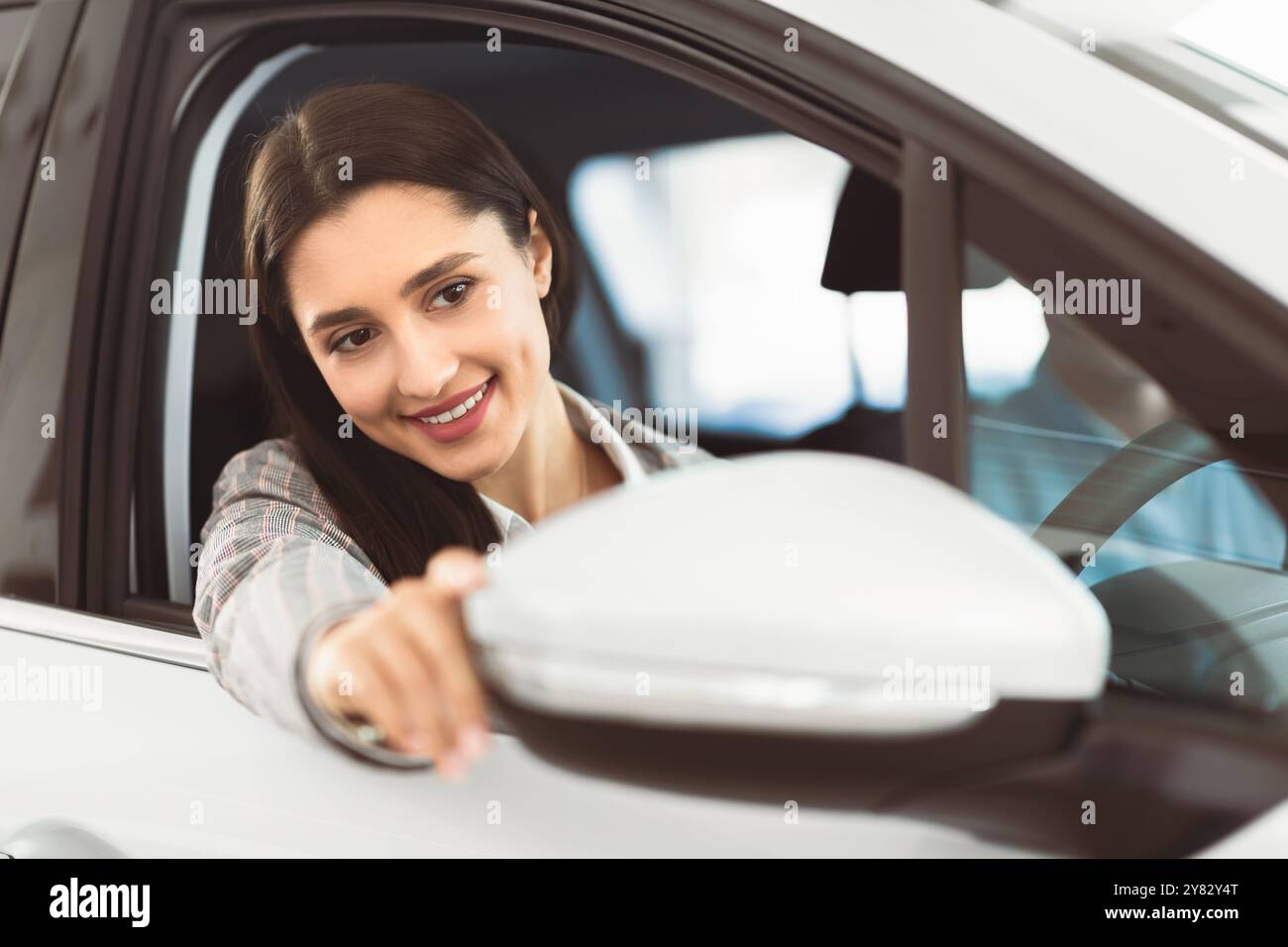 Happy Lady Sitting In Driver's Seat In Car Dealership Center Stock ...
