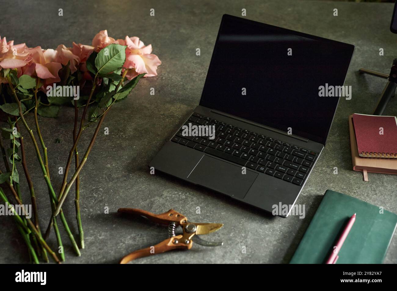 Elegant background composition of open laptop with flowers on textured ...