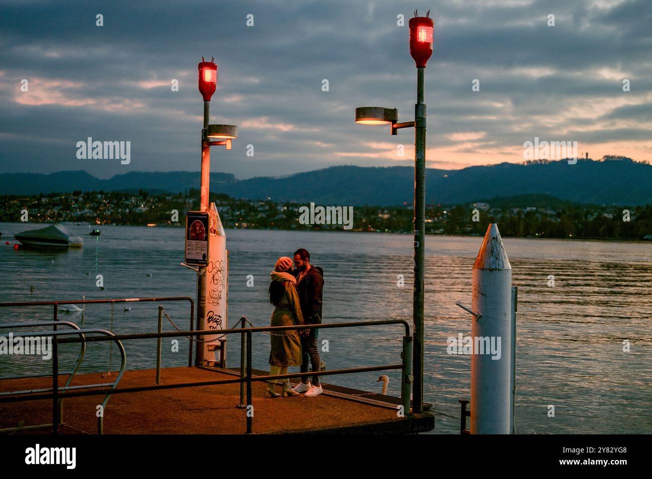 Couple hugs each other on bridge at sunset In Zurich, Switzerland Stock ...